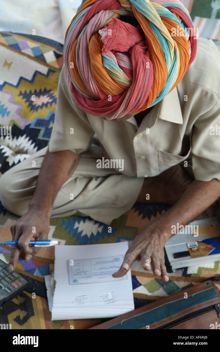Carpet salesman processing a payment in India Stock Photo - Alamy