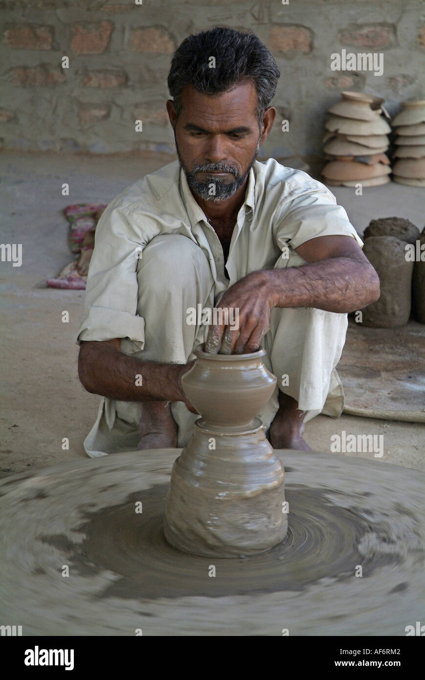 Man making clay pots in a Bishnoi village outside of Jodhpur in India ...