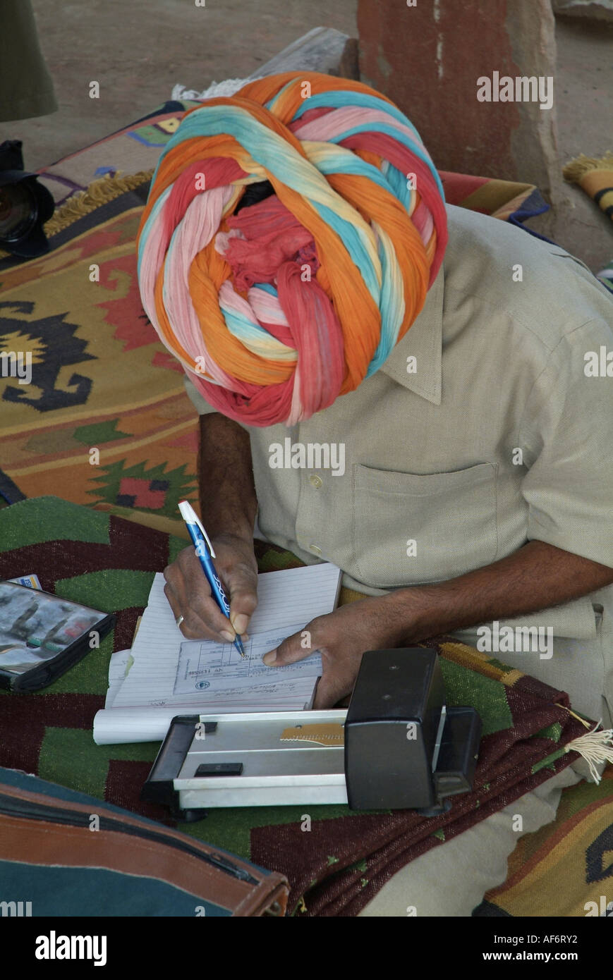 Carpet salesman processing a payment in India Stock Photo - Alamy
