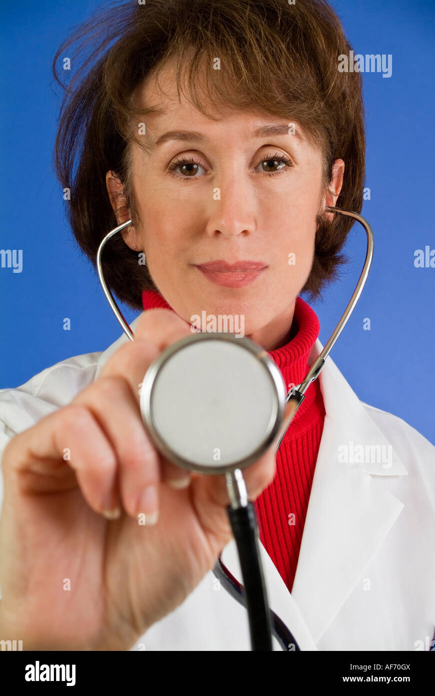 A woman with a stethoscope in her hand acting as if she is going to ...
