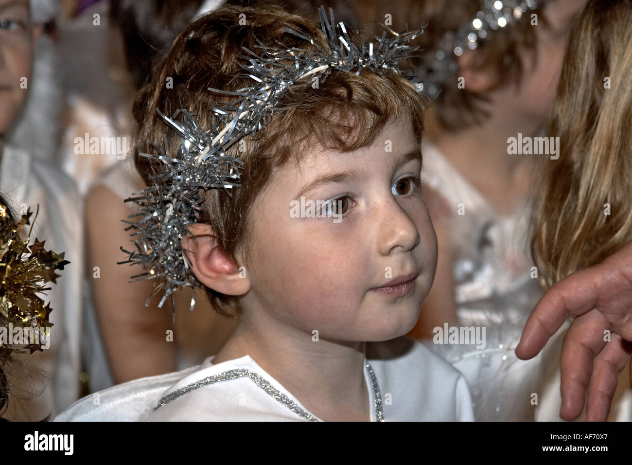 Attractive young boy child dressed as angel in primary school nativity ...