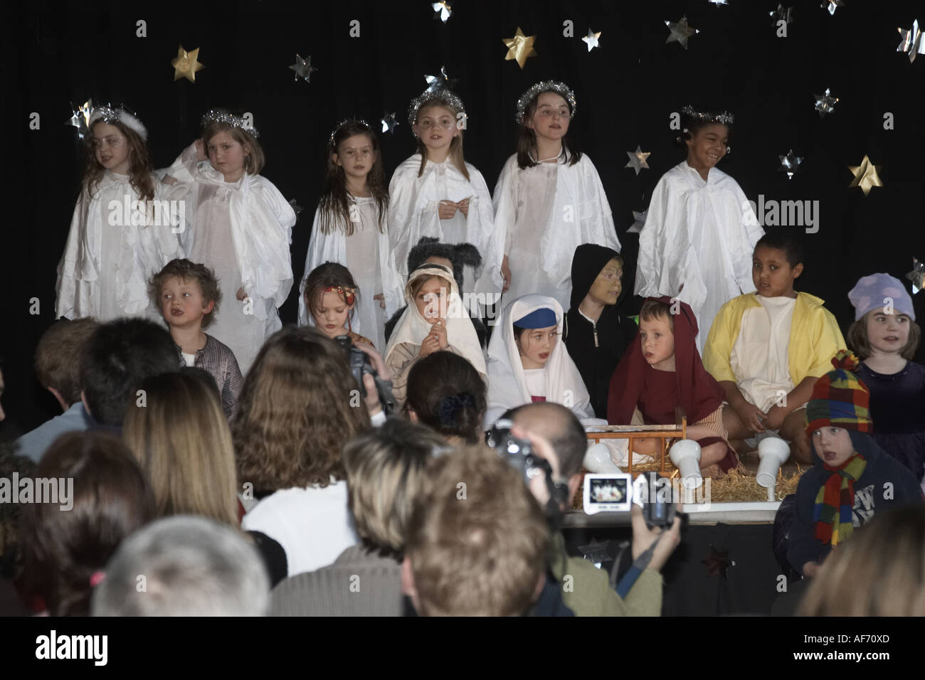 Young children dressed as angels and shepherds choir in primary school ...