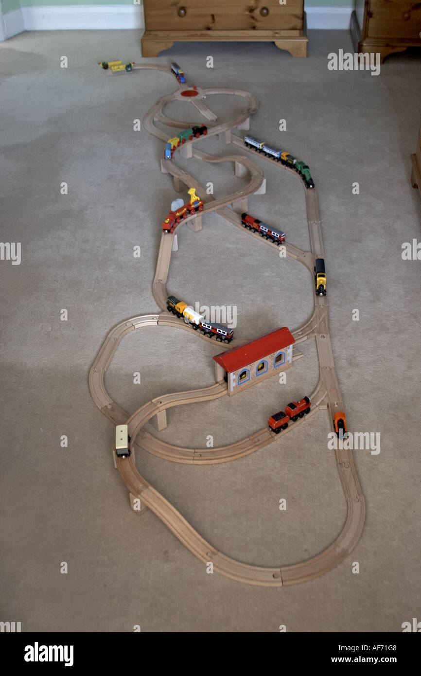 Wooden train set with train track laid out in childs bedroom Stock ...