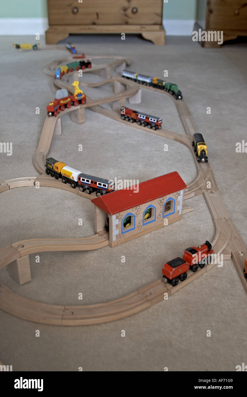 Wooden train set with train track laid out in childs bedroom Stock ...