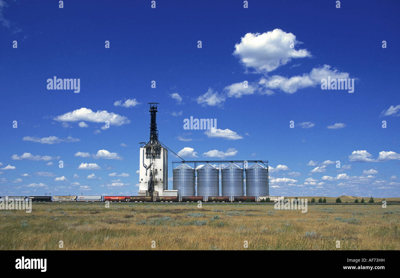 Giant grain silos and a freight train on the Great Plains farmland ...