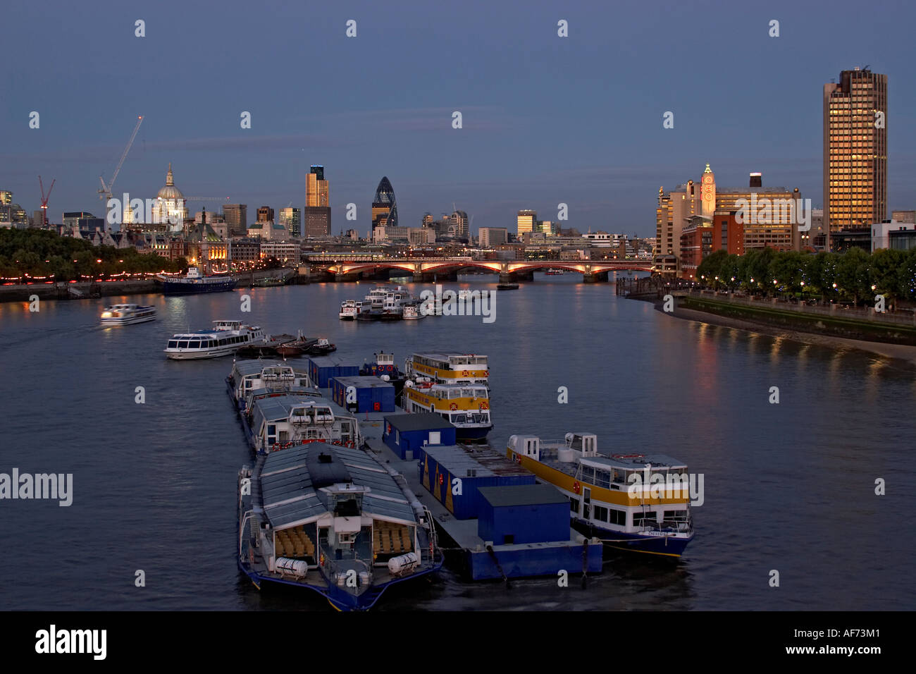 City and River Thames boats and barges from Waterloo Bridge skyline at ...