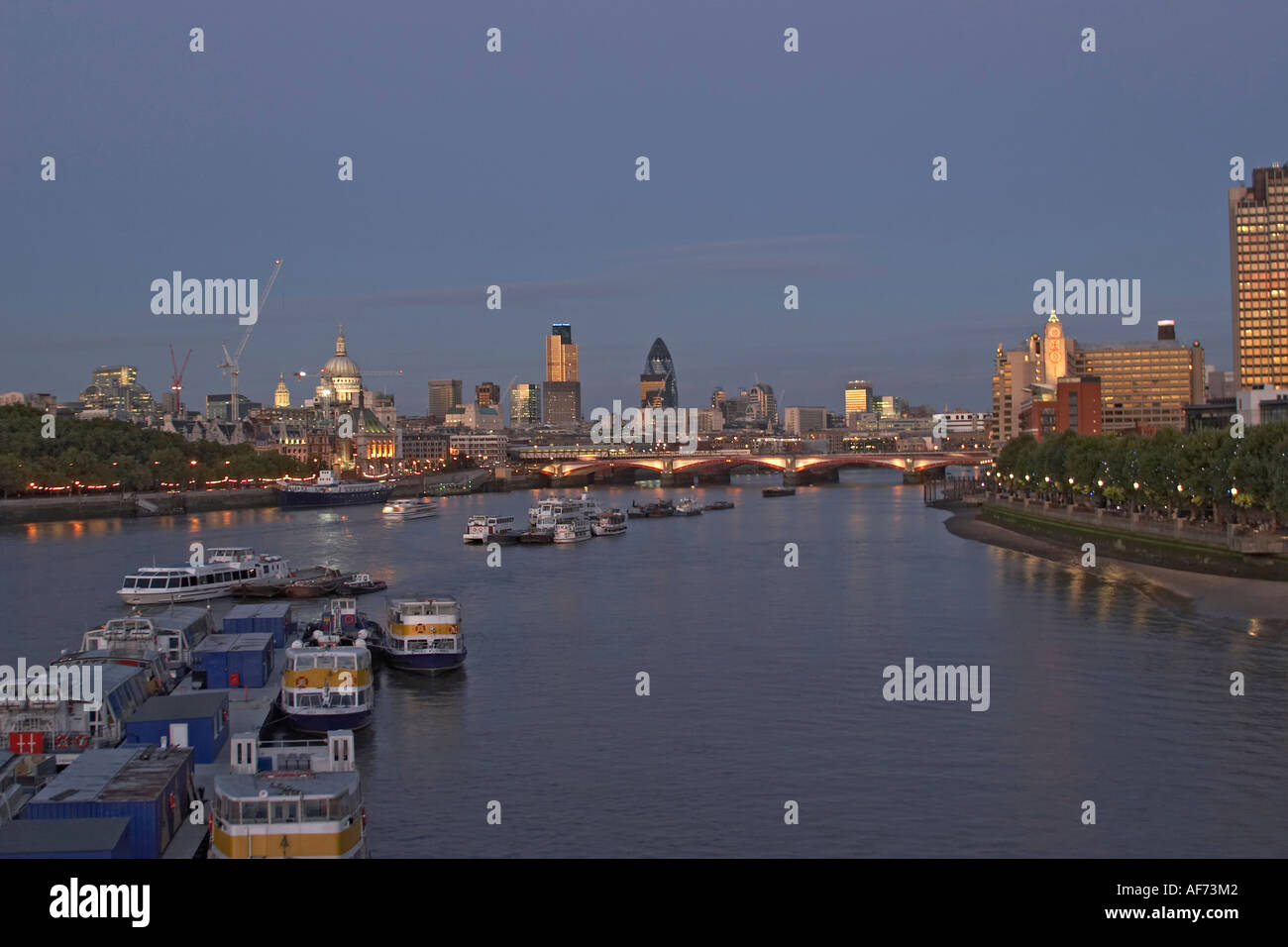 City and River Thames boats and barges from Waterloo Bridge skyline at ...