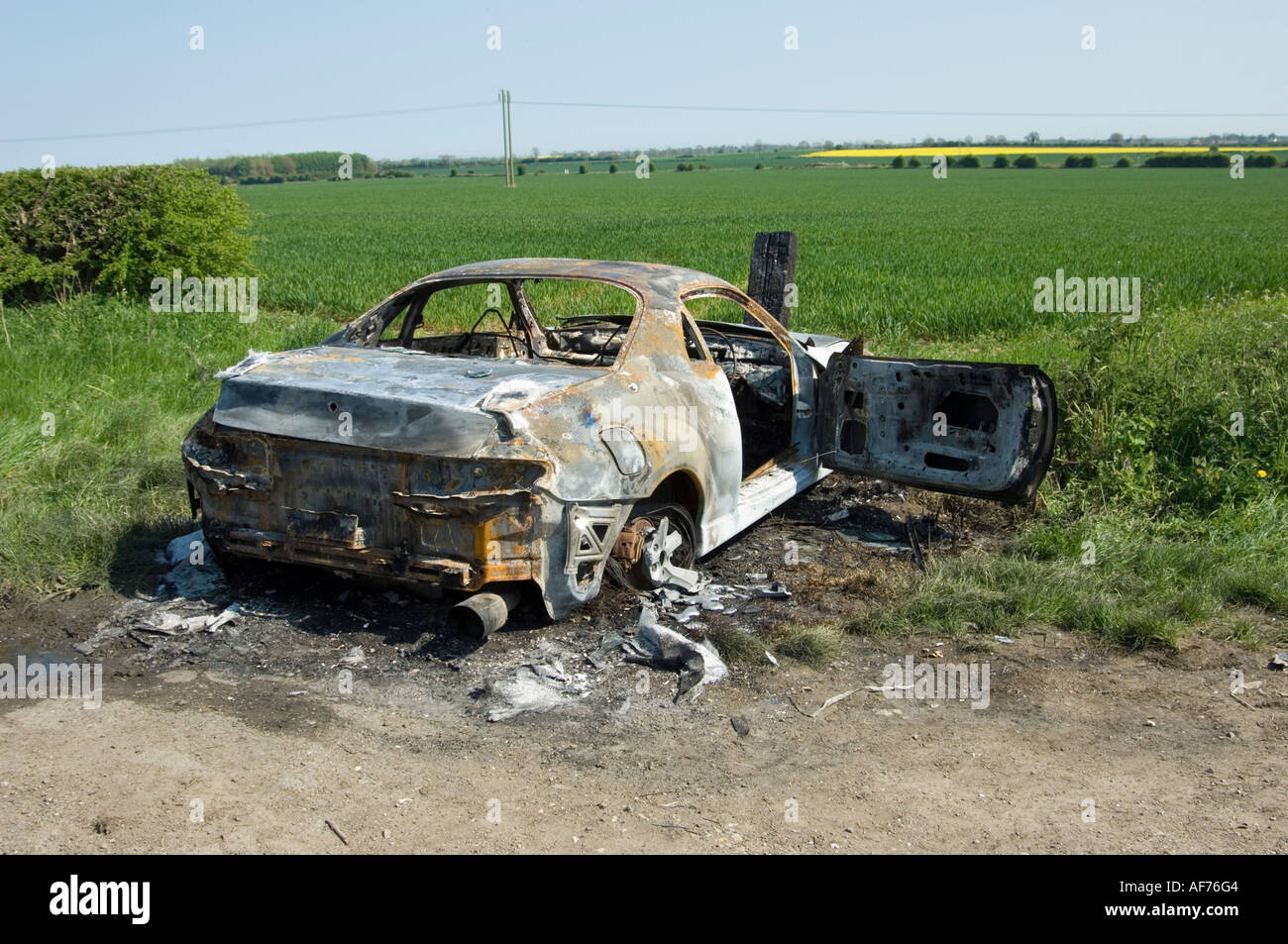 Burnt out BMW sports car on a country lane Stock Photo - Alamy