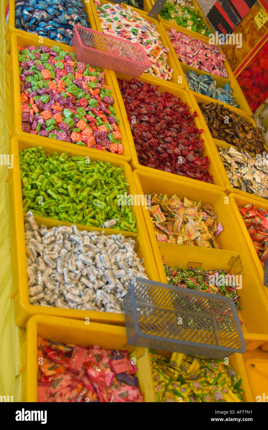 trays of colourful sweets and candies being sold at a bazaar stall in ...