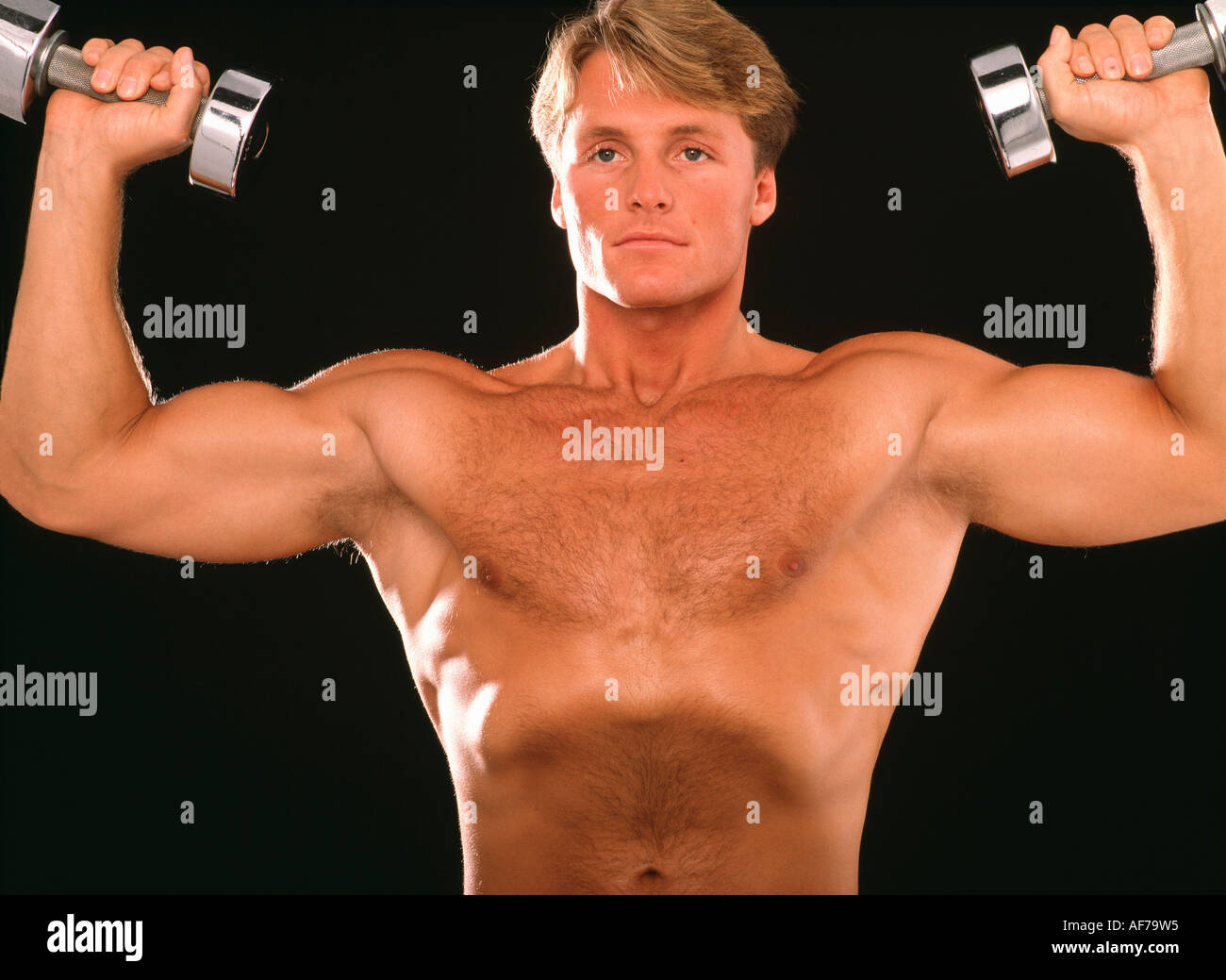 Young man indoors body builder. Weight training Stock Photo - Alamy