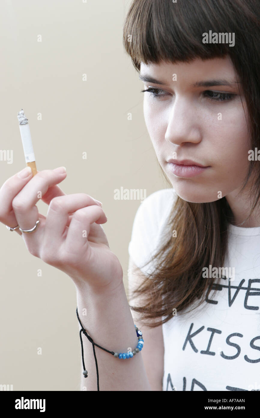 Teenage girl smoking cigarette. She wants stop smoking Stock Photo - Alamy