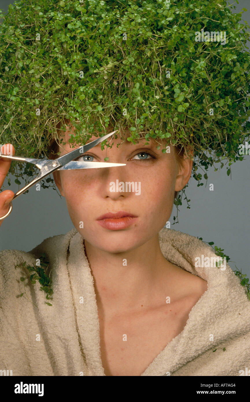 Surreal image of woman using scissors to cut water cress hair Stock ...