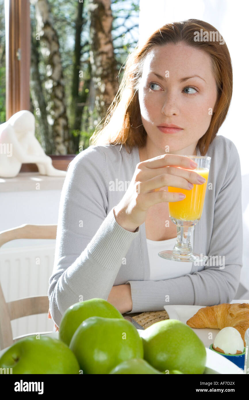 woman drinking orange juice Stock Photo - Alamy