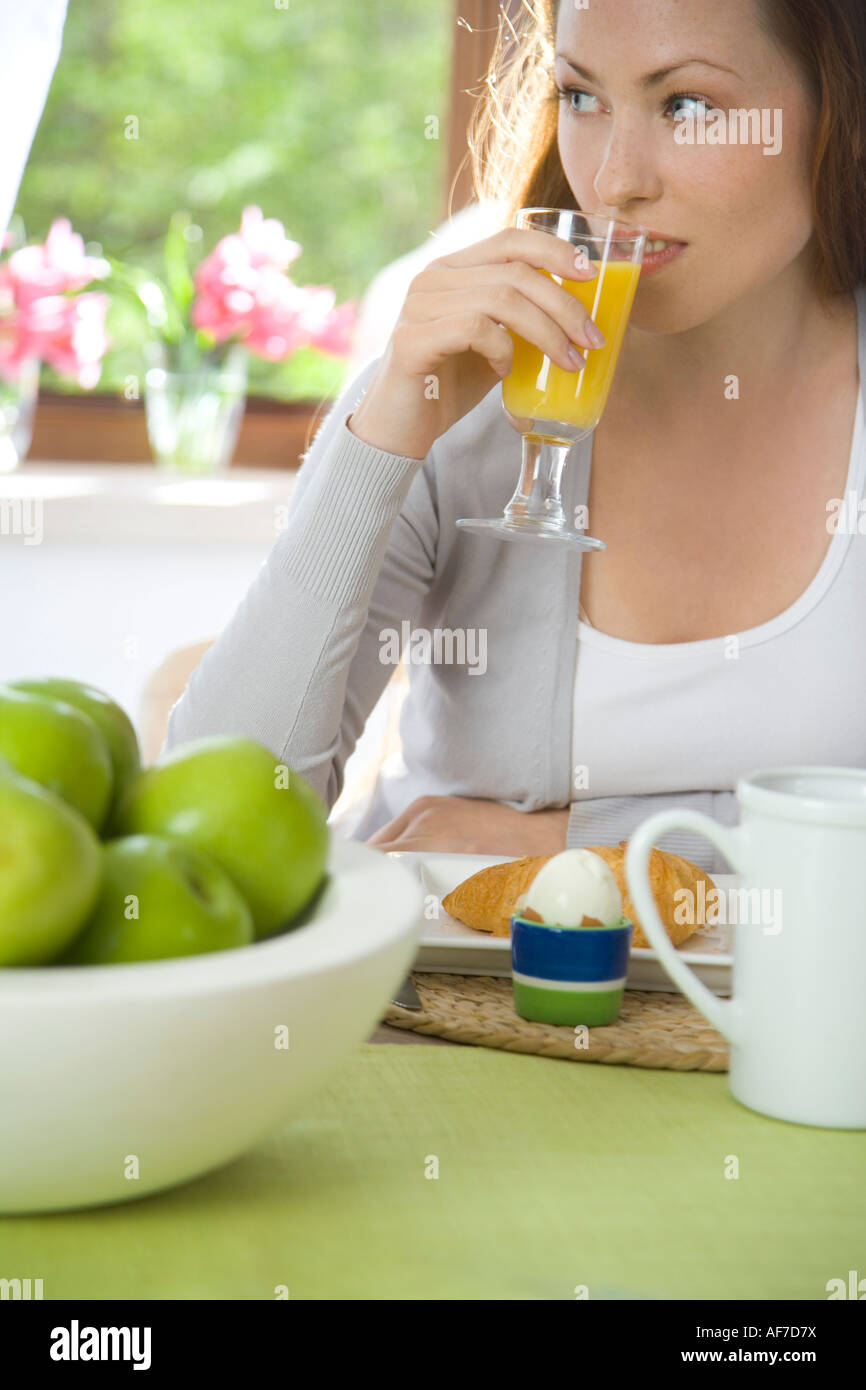 woman drinking orange juice Stock Photo - Alamy