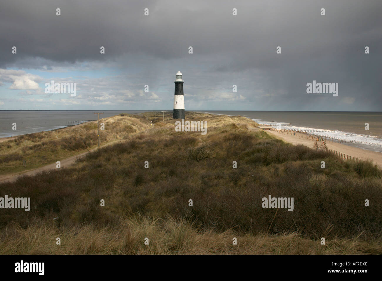 Spurn head lighthouse storm clouds narrow sand spit on the tip of the ...