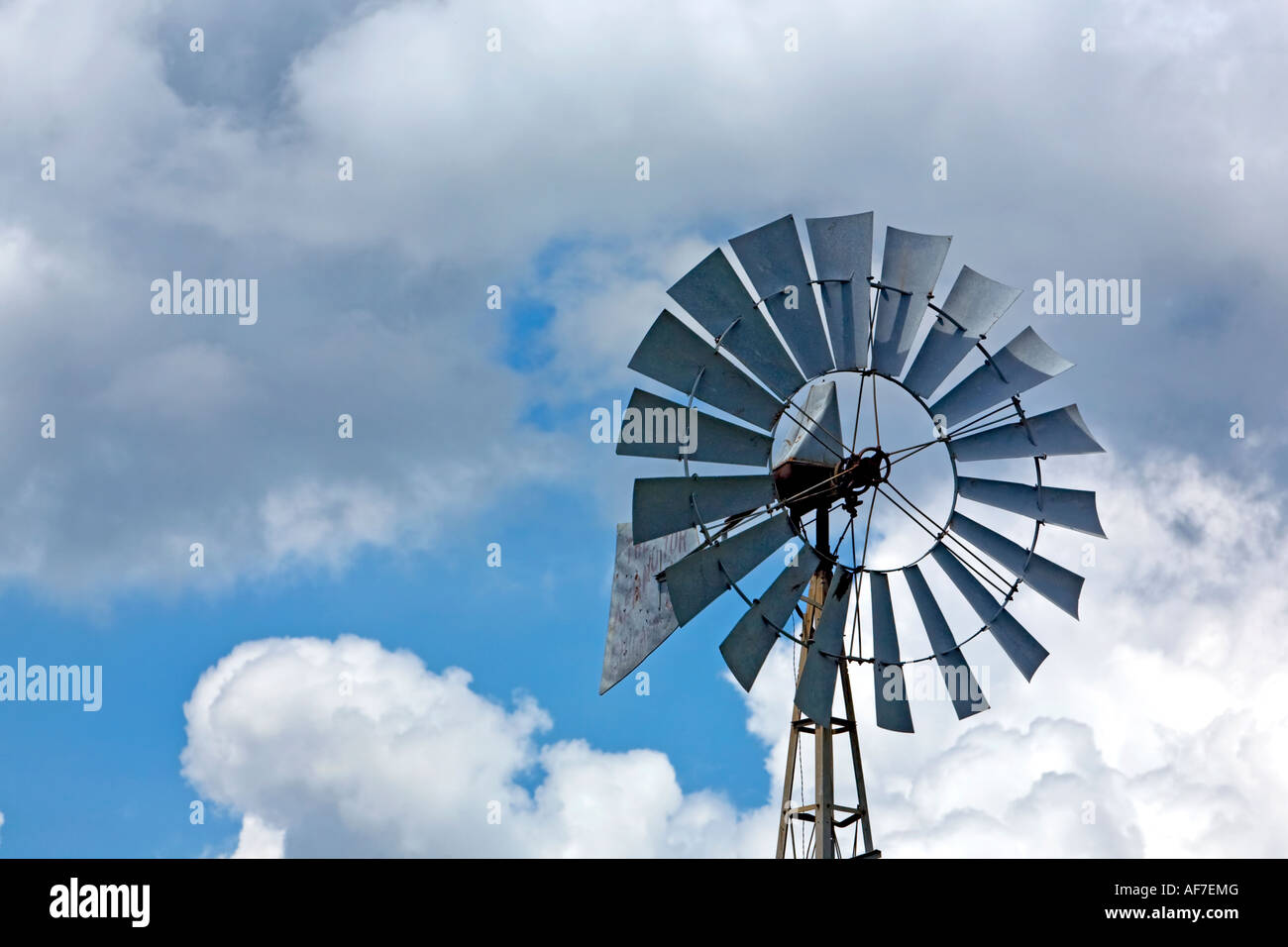 Windmill top in blue cloudy sky Texas farm Stock Photo - Alamy
