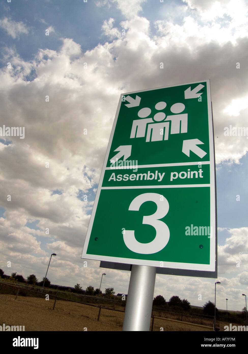 Assembly point sign post at a place of work Stock Photo - Alamy