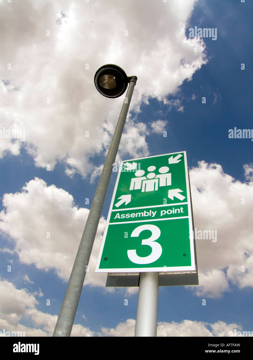 Assembly point sign post at a place of work Stock Photo - Alamy