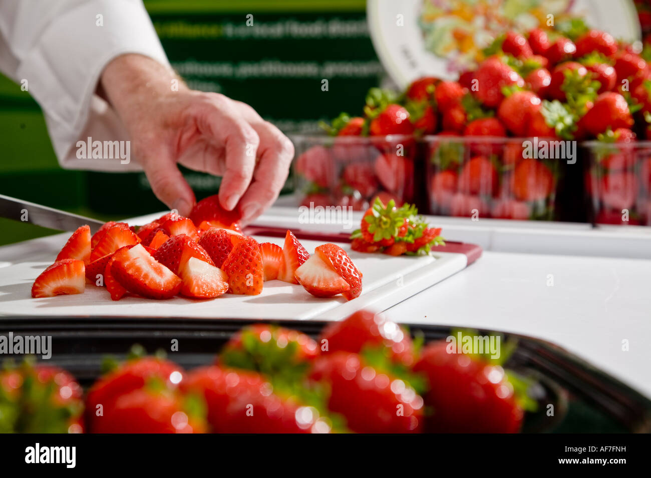 Strawberries being chopped up for displaying and serving Stock Photo ...