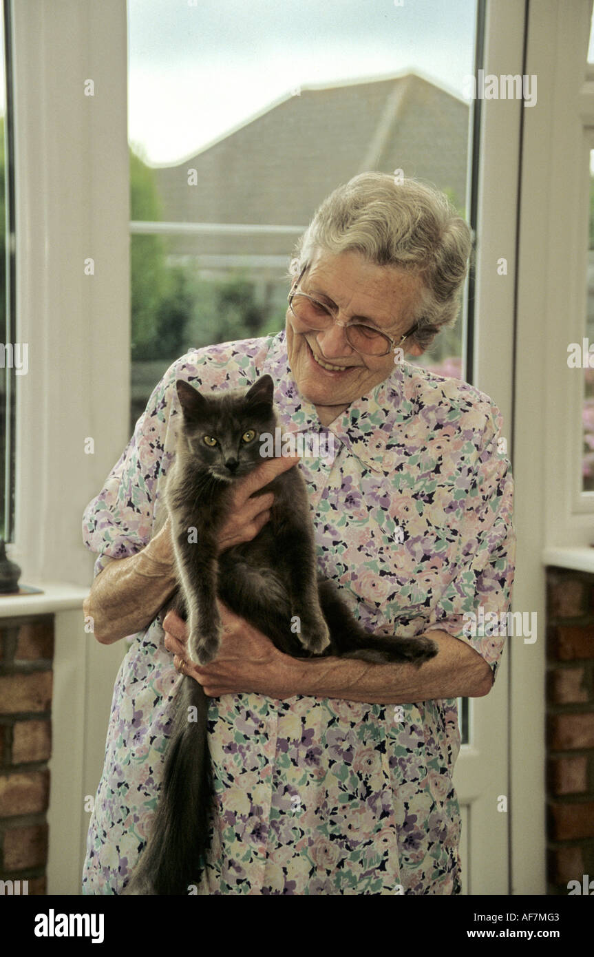 Old woman cuddling cat hi-res stock photography and images - Alamy