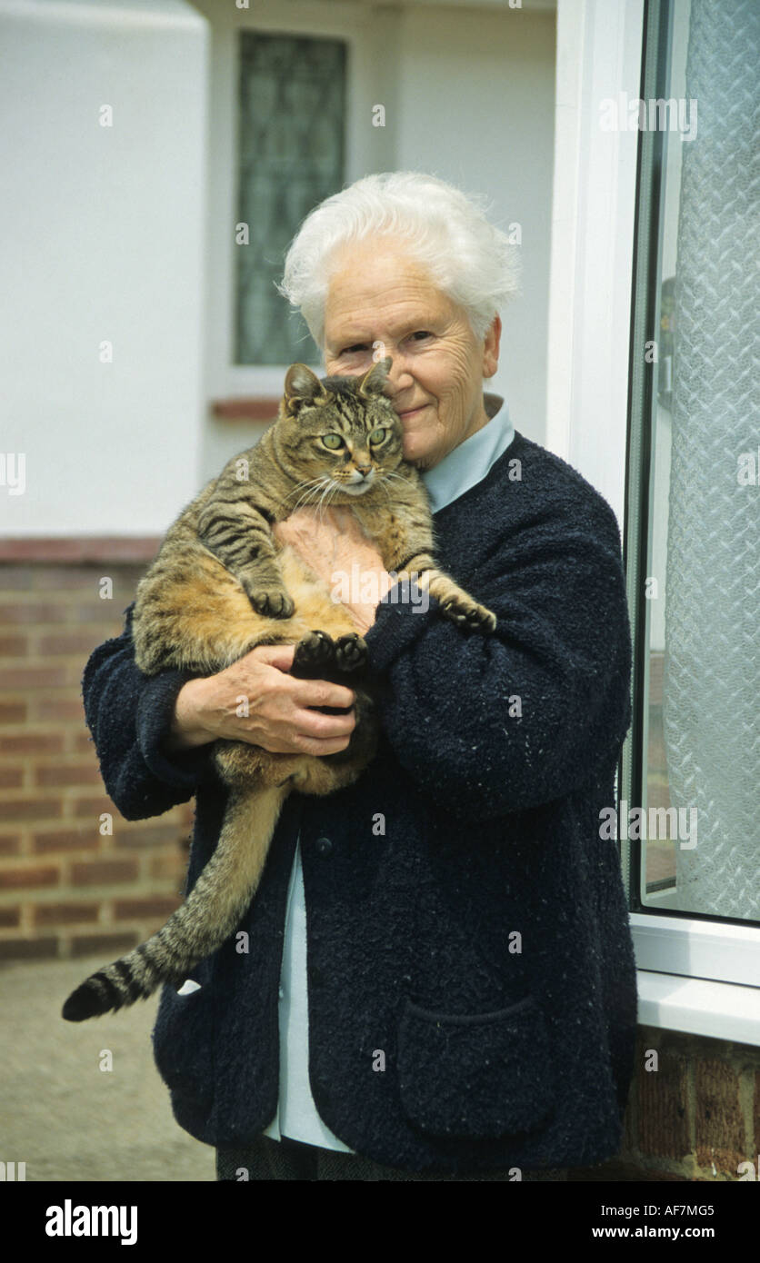 Old woman cuddling cat hi-res stock photography and images - Alamy