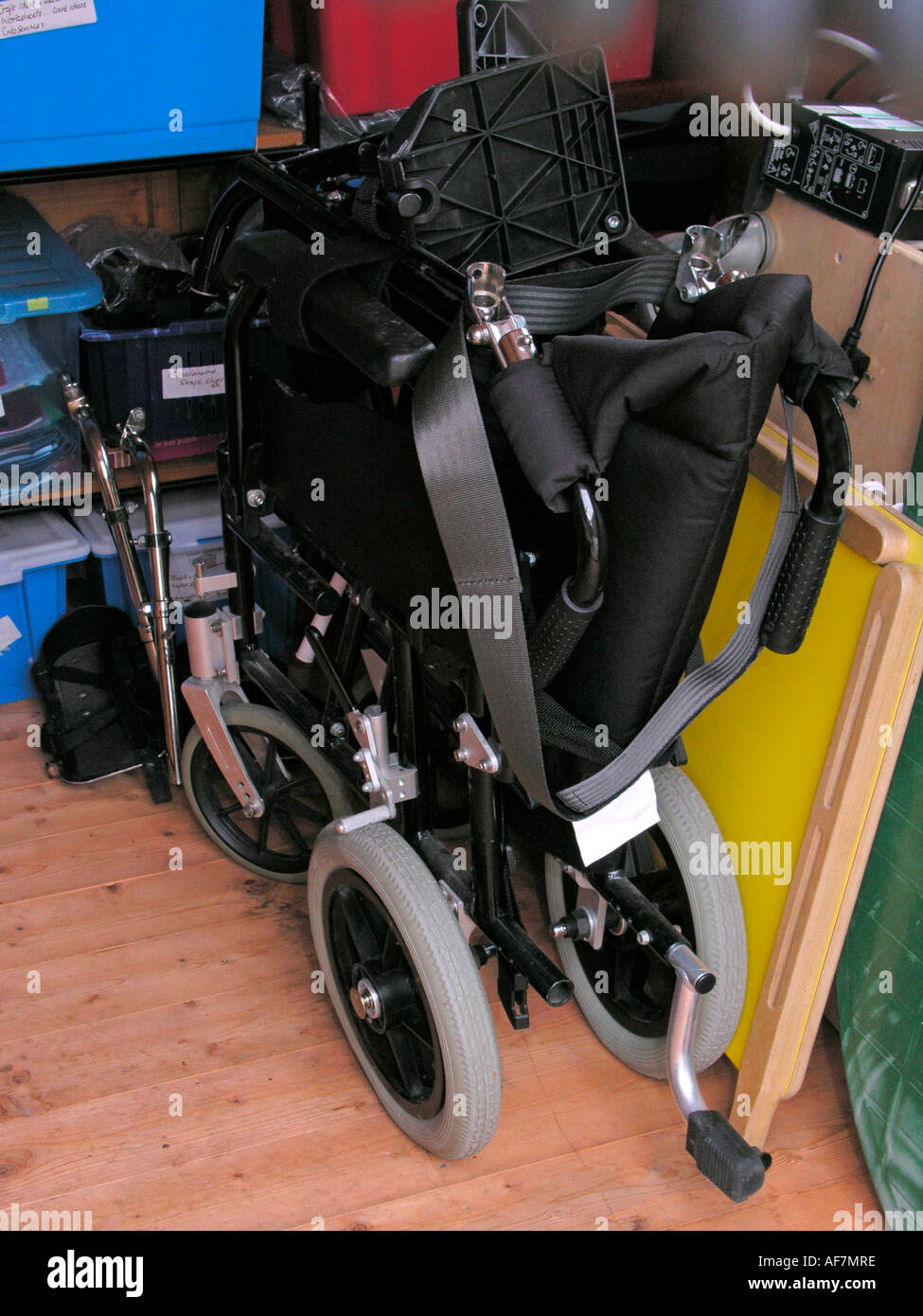 wheelchair folded and closed in shed for easy storage when not in use ...