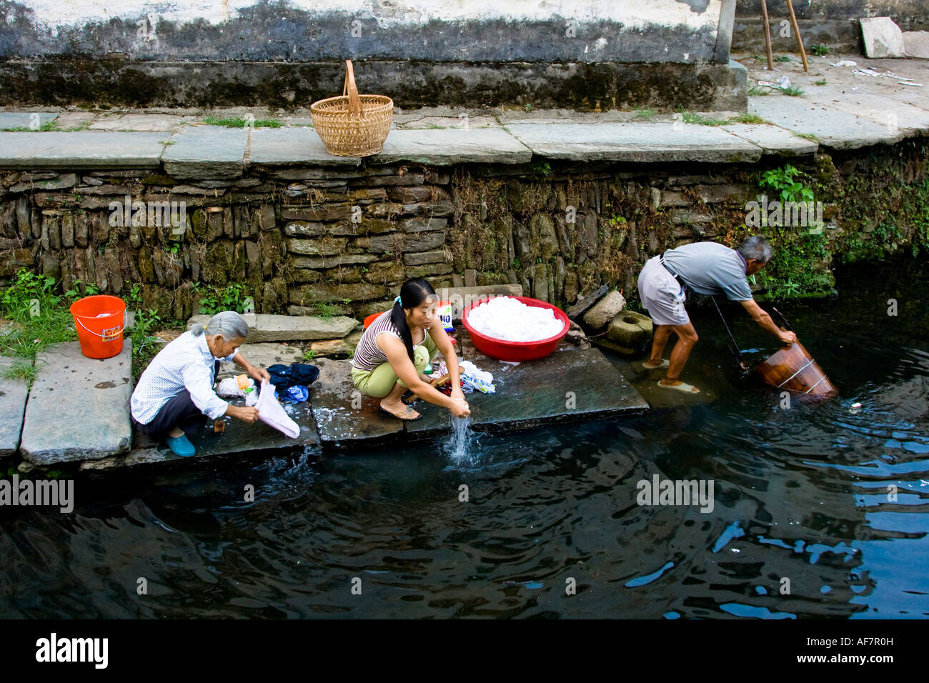 Woman handwashing clothes hi-res stock photography and images - Alamy