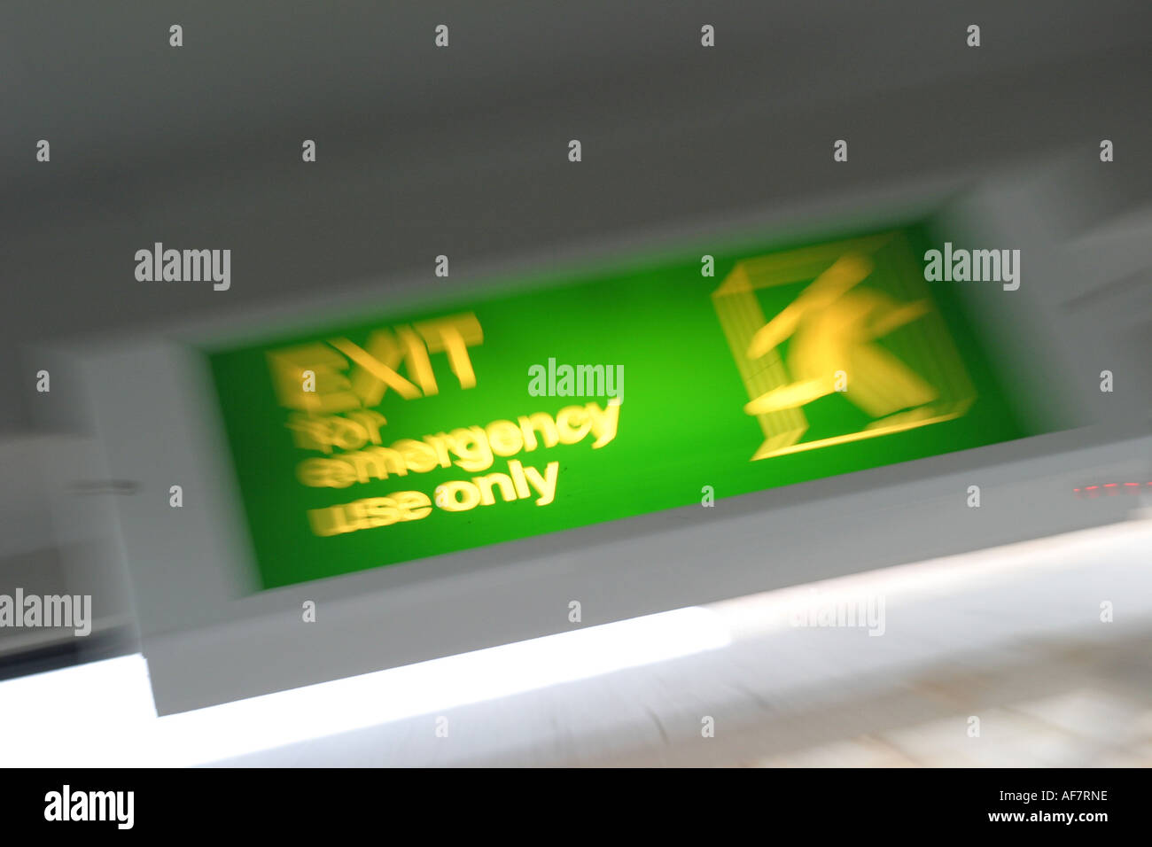 A Stock Photograph of a Emergency Exit Sign on a Wall in a Building ...