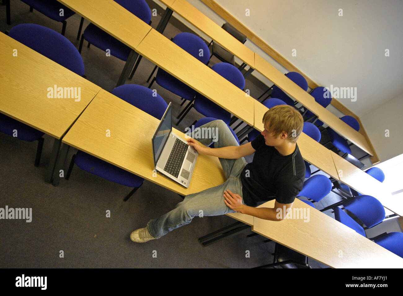 A Stock Photograph of a University Student Typing on a Laptop in a ...