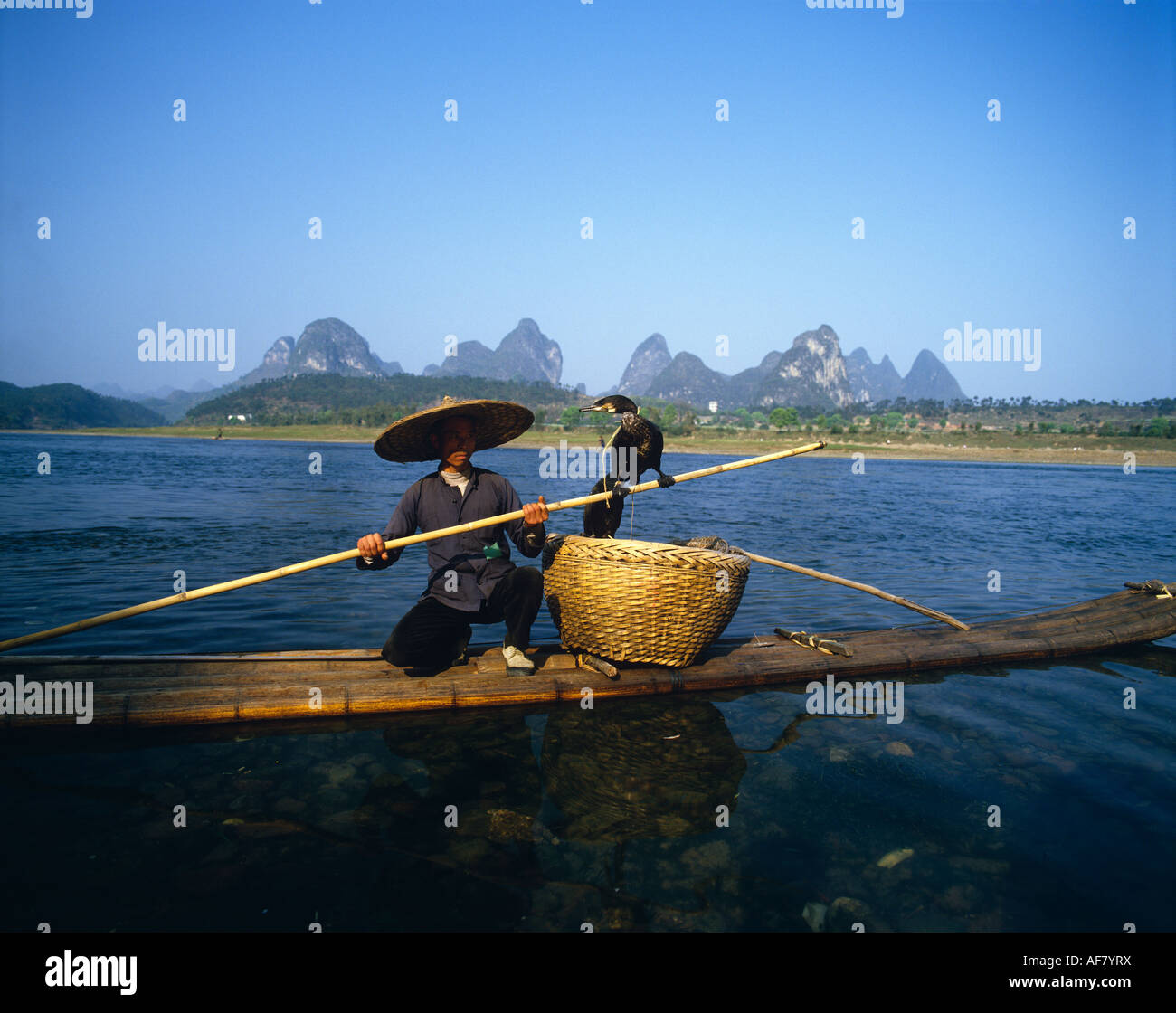 China man on boat with basket Stock Photo - Alamy