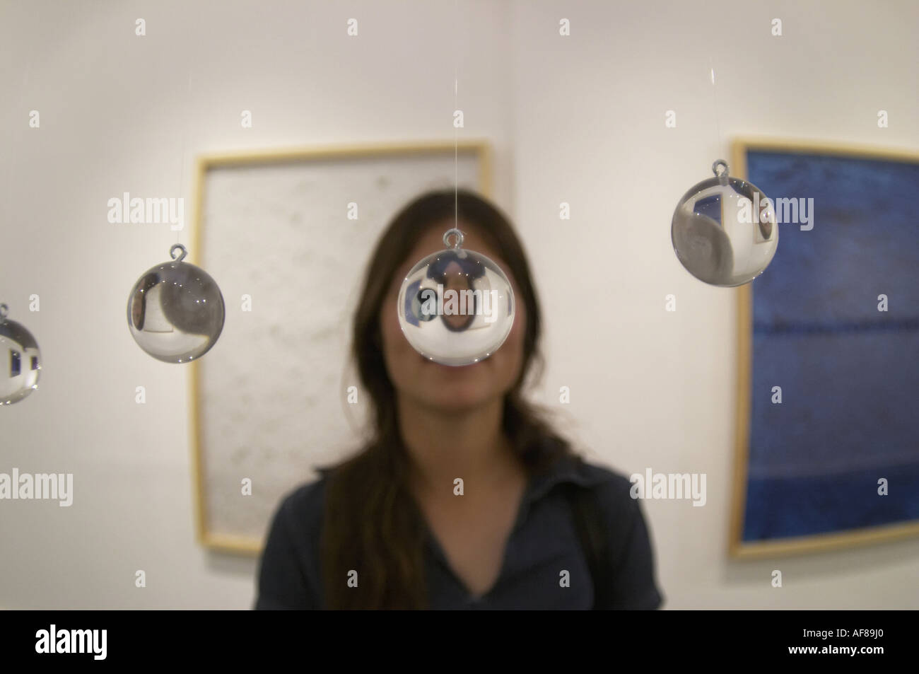 Modern art show, girl and glass balls Stock Photo - Alamy