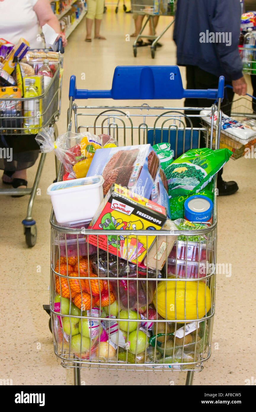 a supermarket trolley full of food in tesco's, Carlisle, Cumbria, UK ...