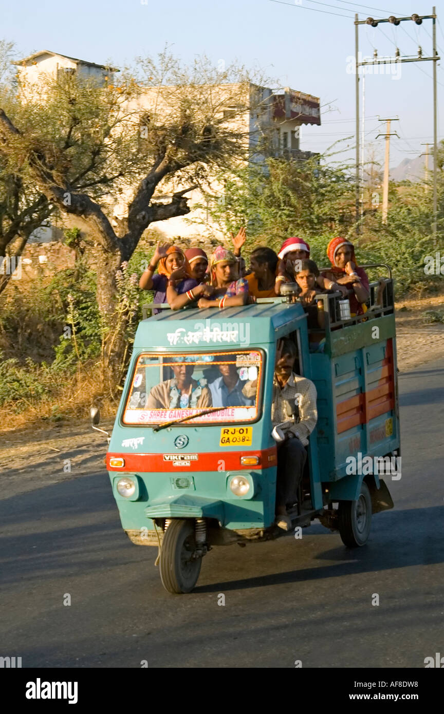 Vertical view of lots of Indian women hitching a lift in the back of an ...