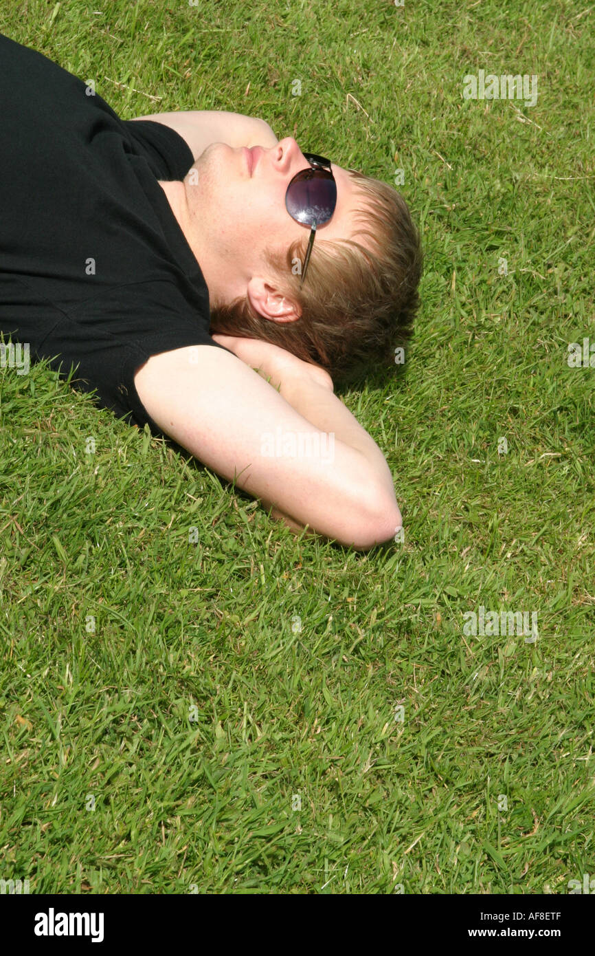 A Stock Photograph of a University Student Laying on Grass Relaxing in ...