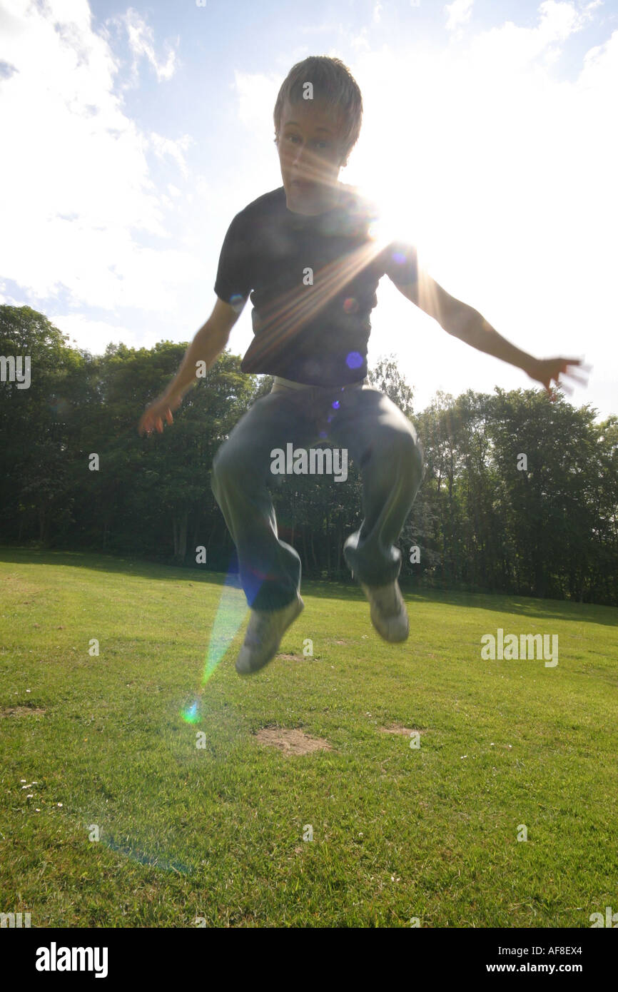 A Stock Photograph of a Student Jumping and Playing in a Park Area ...