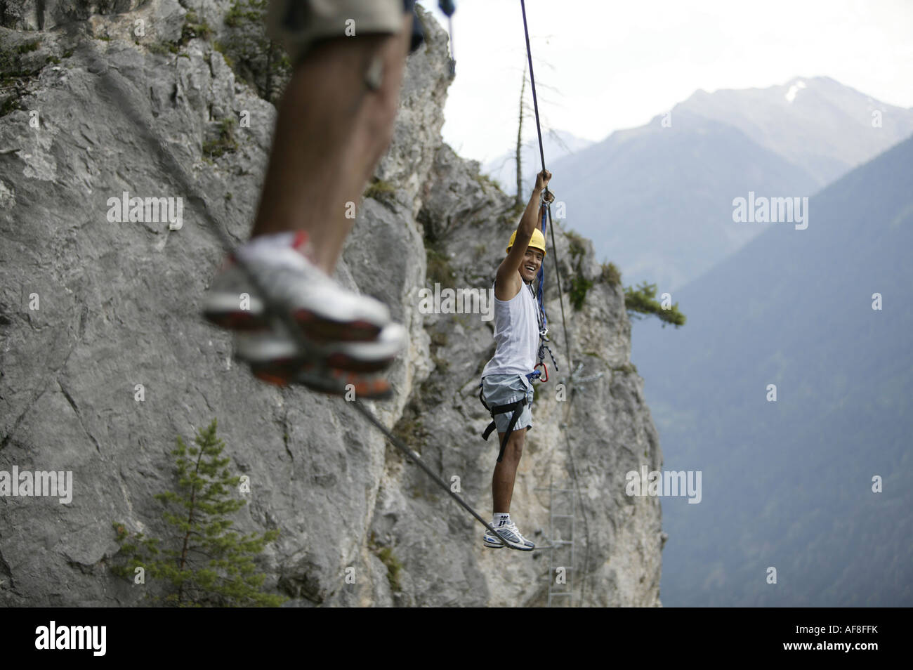 Two men climbing on a rope bridge at Crazy Eddy in Silz, Haiming in the ...