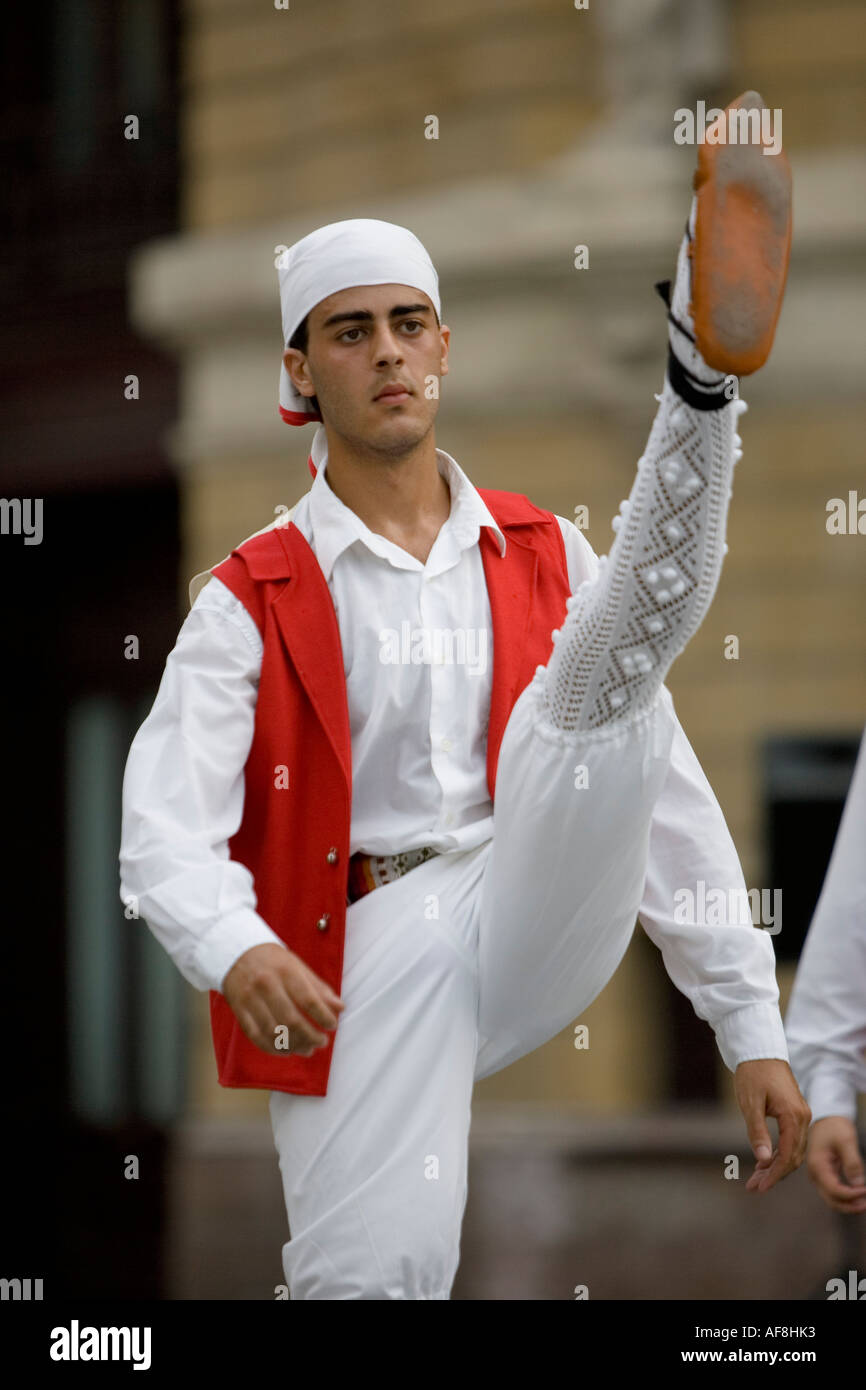 Man kicking leg in air during Basque folk dancing Plaza Arriaga Bilbao ...