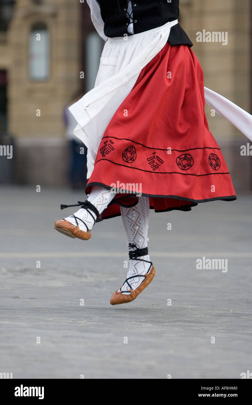 Woman jumping as she performs a Basque folk dance Plaza Arriaga Bilbao ...