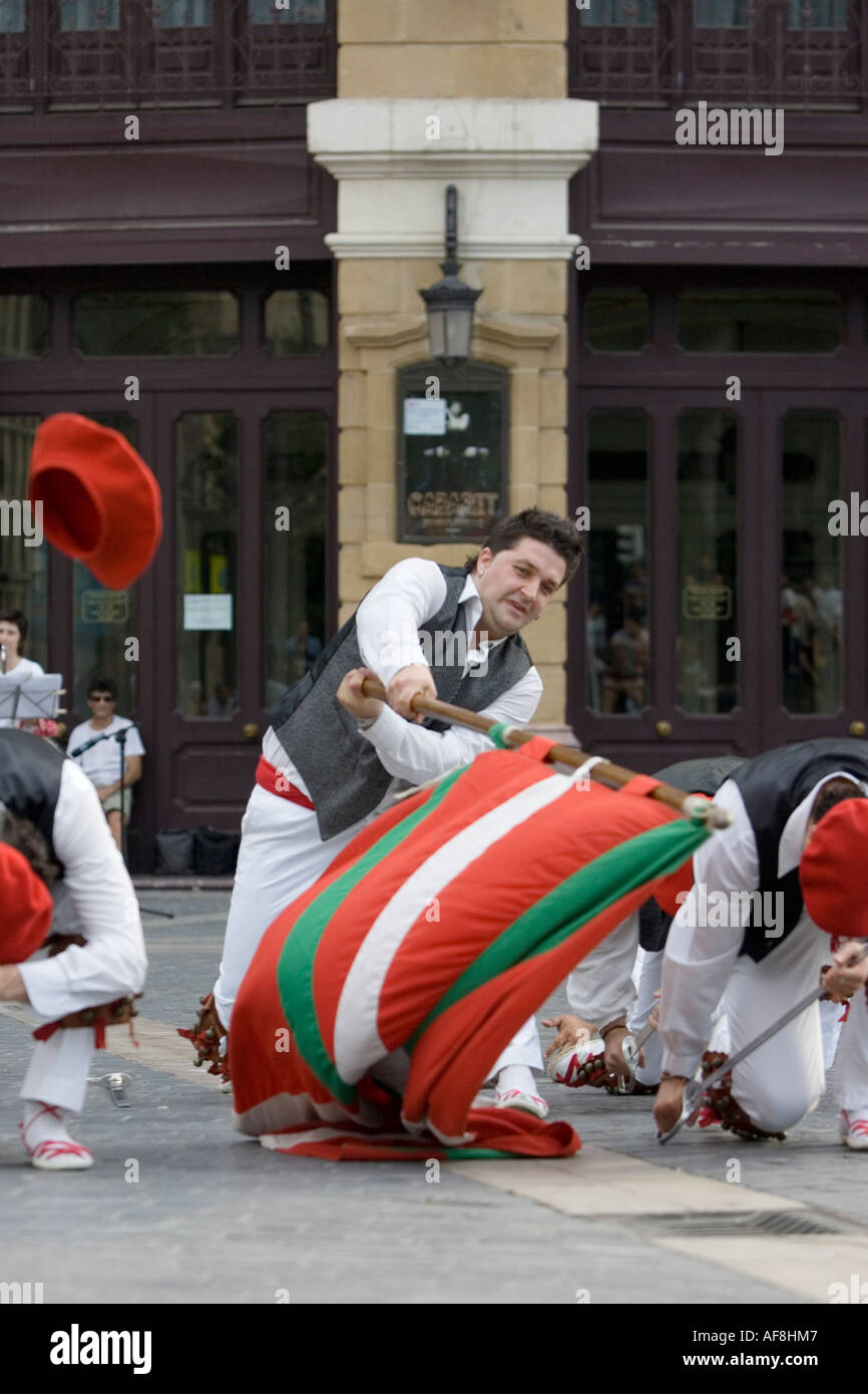 Man waving Basque national flag, the Ikurrina, during folk dance Plaza ...