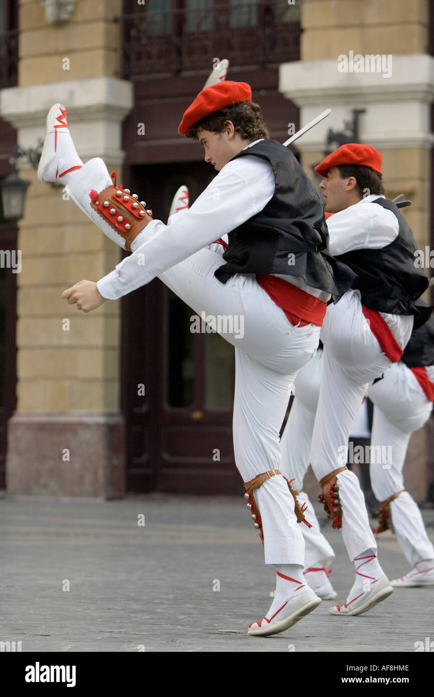 Men kicking legs in air during Basque folk dancing Plaza Arriaga Bilbao ...