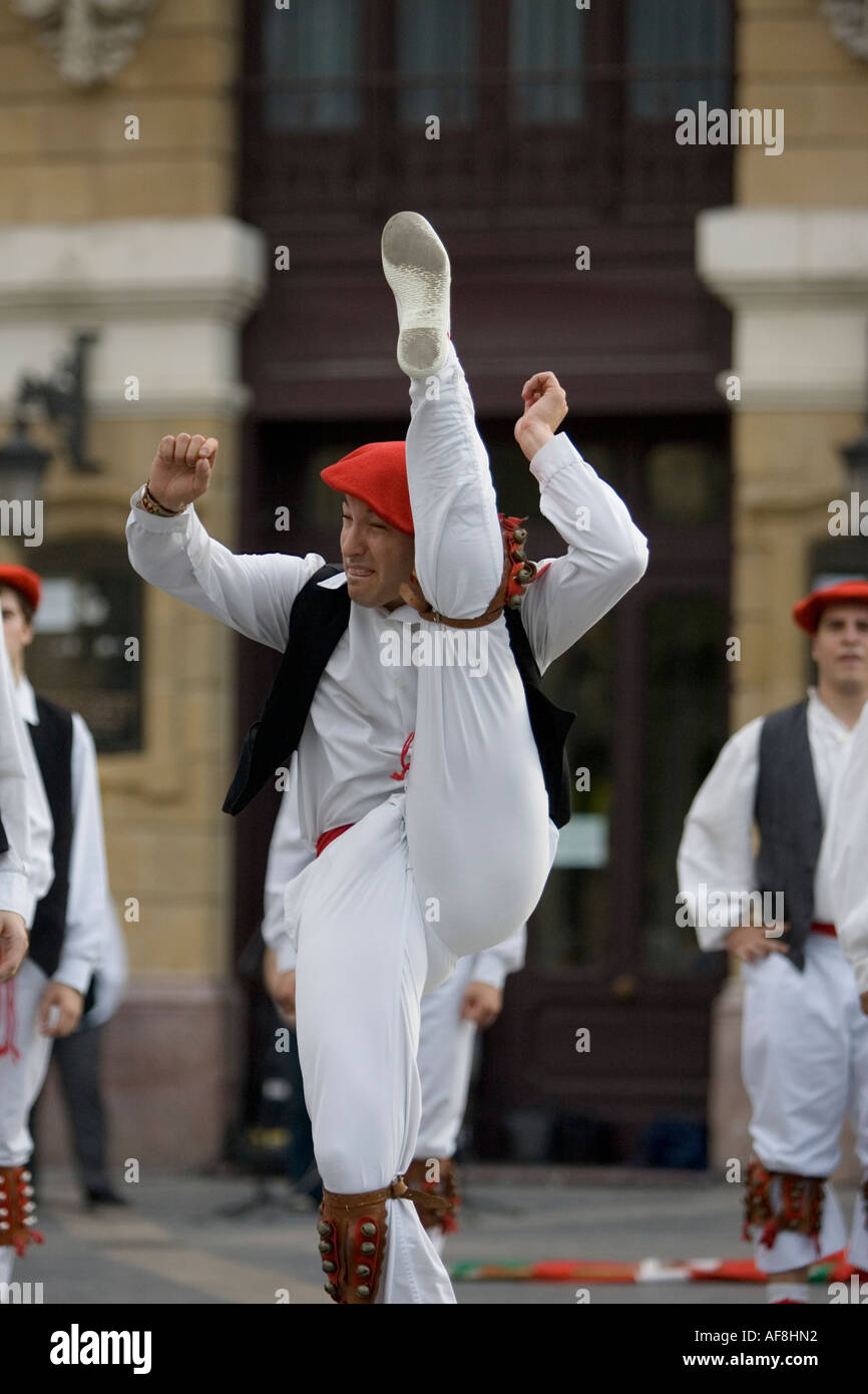 Man kicking leg in air during Basque folk dancing Plaza Arriaga Bilbao ...