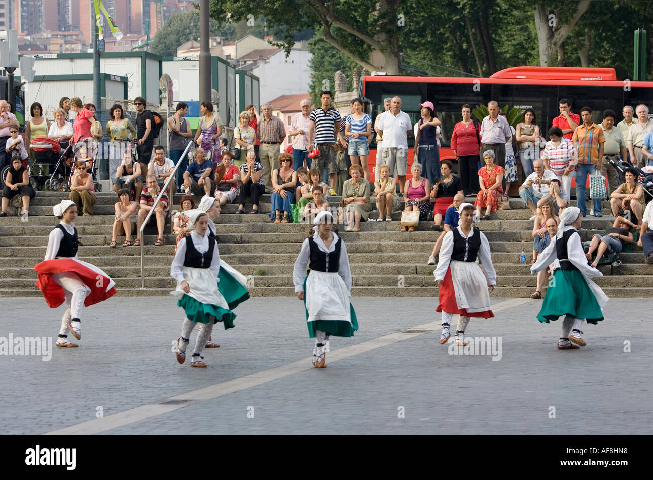 Tourists watching Basque folk dancing Plaza Arriaga Bilbao Pais Vasco ...