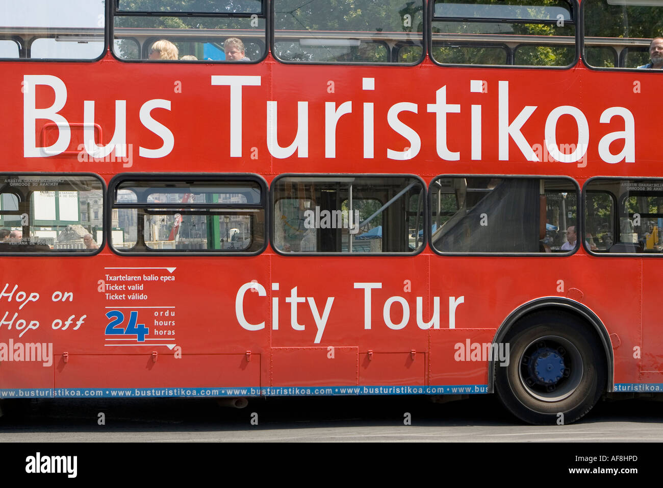 The words Bus Turistikoa on side of red double decker sightseeing bus ...