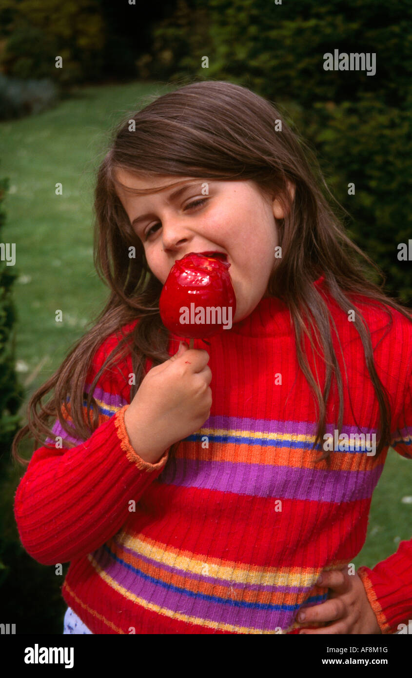 Child Eating Toffee Apple 6 Year Old Stock Photo - Alamy