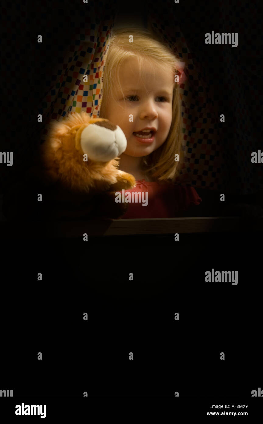 Little girl performs puppet show with lion Stock Photo - Alamy