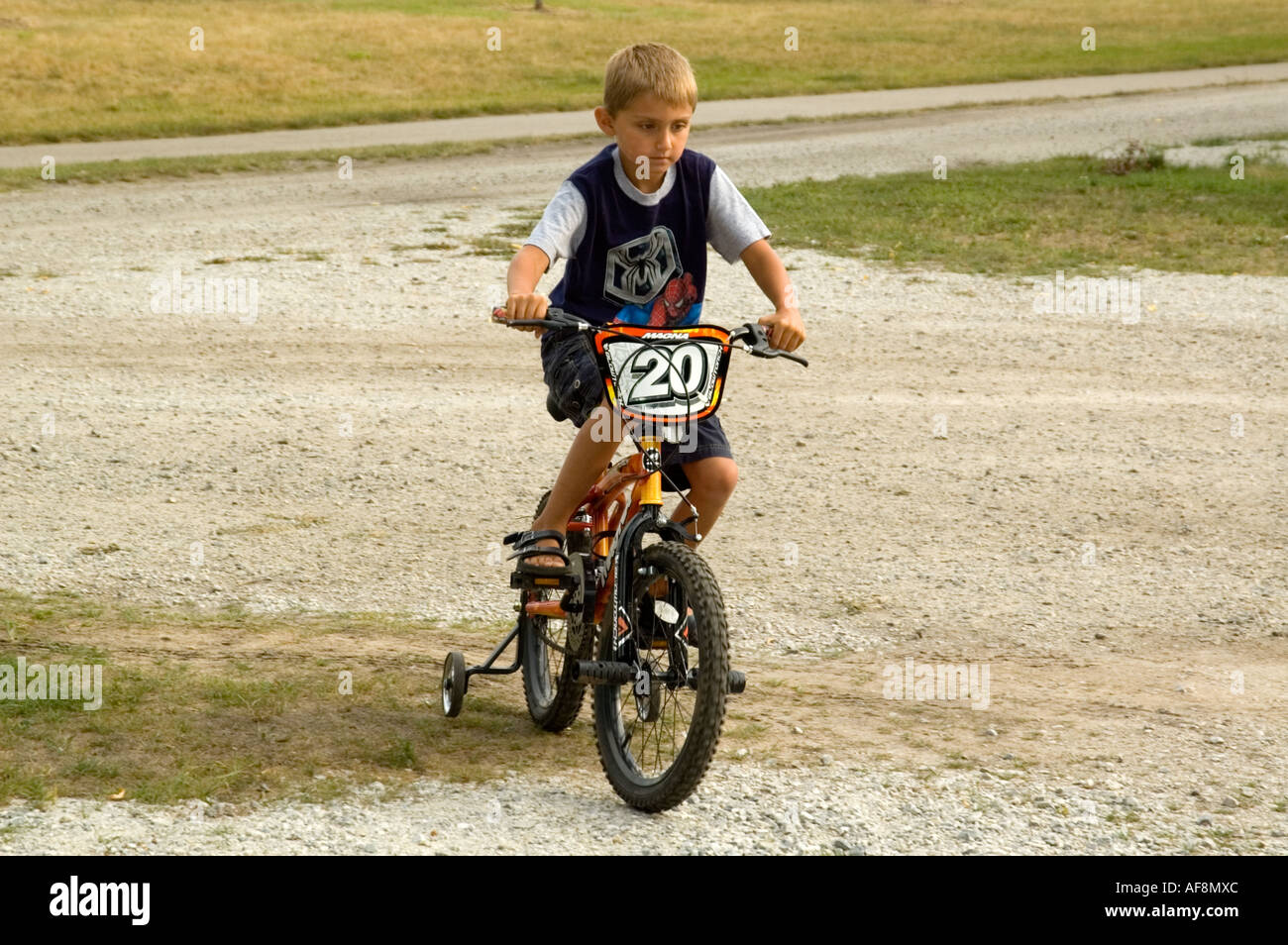 Boy riding bike training wheels hi-res stock photography and images - Alamy