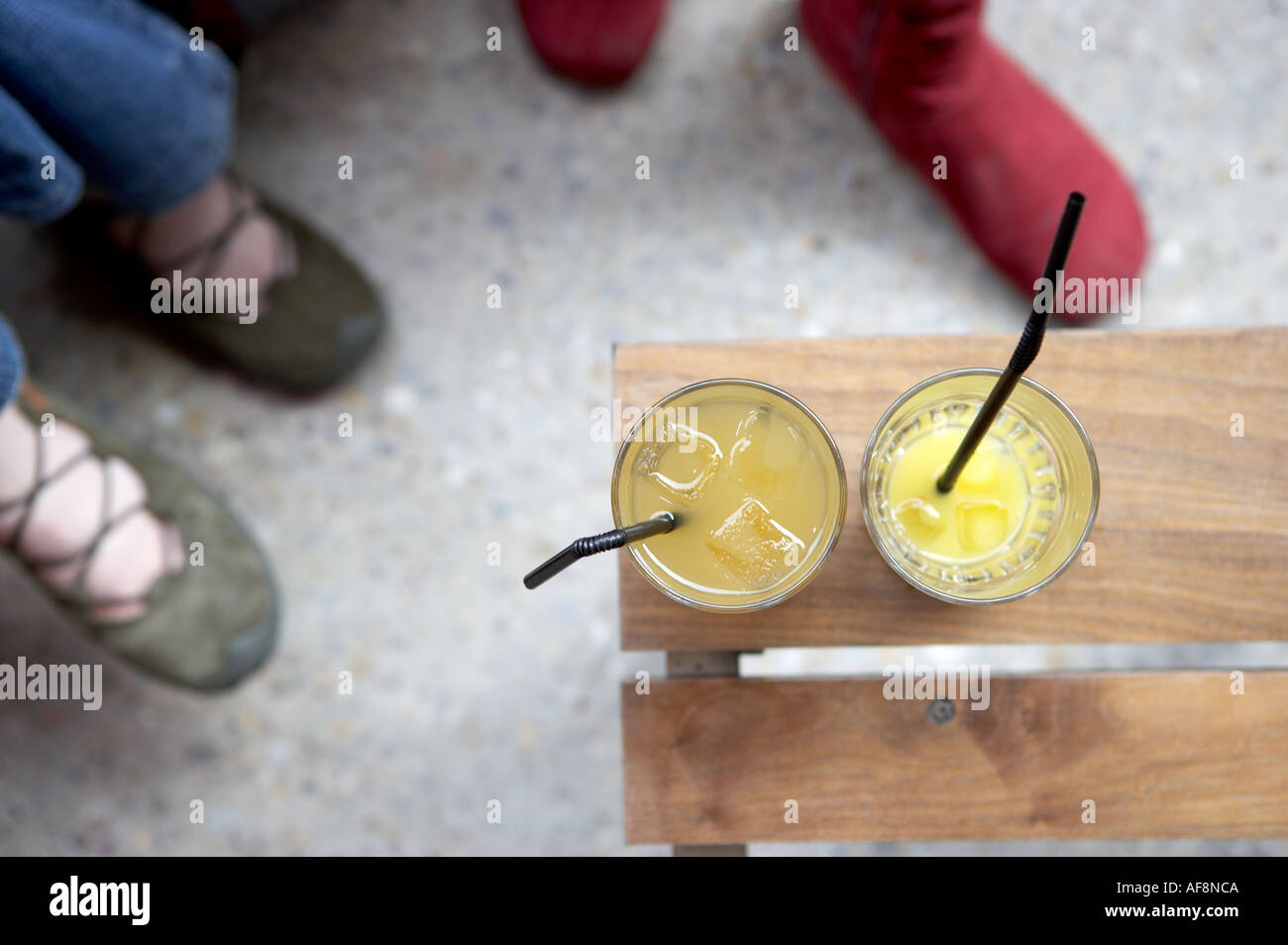legs of 2 women drinking in a bar Stock Photo - Alamy
