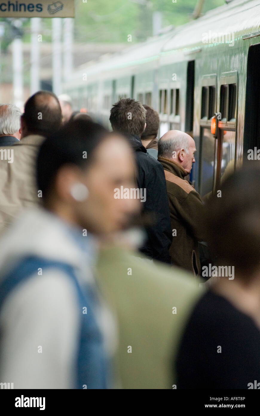 Passengers waiting to board a train in the uk Stock Photo - Alamy