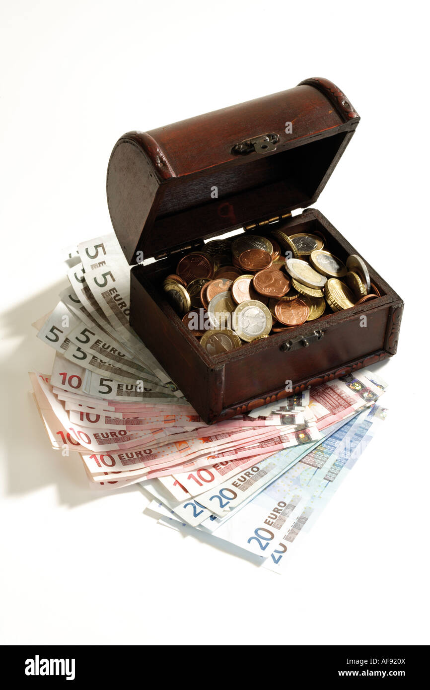 Open cash, full of coins, standing on bank notes, elevated view Stock ...