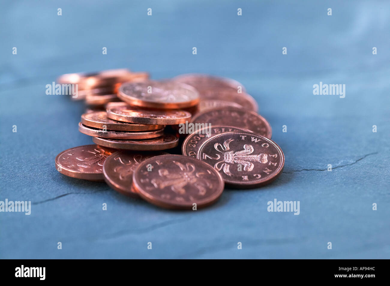 English copper coins laying on gray grey background close up Stock ...